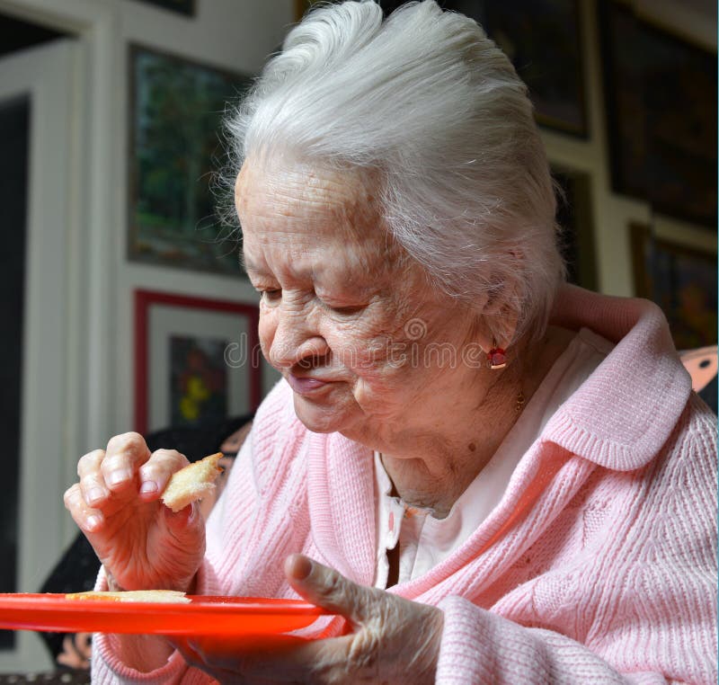 Old Woman Eating a Slice of Bread Stock Image - Image of fresh, dinner ...