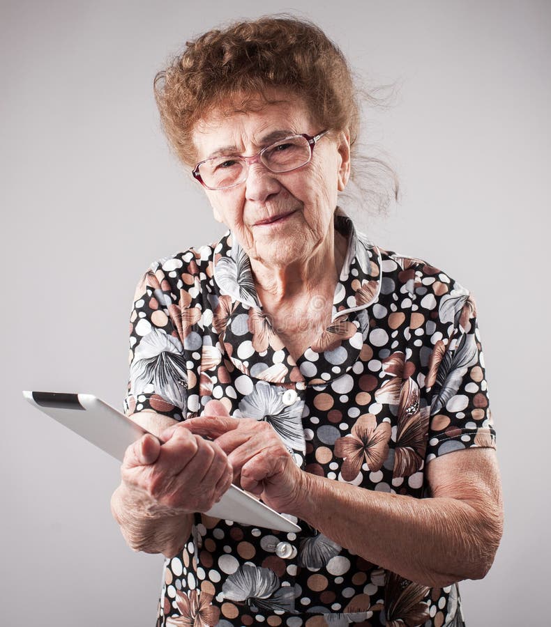Old Woman Holding a Tablet in the Hands of Stock Image - Image of copy ...