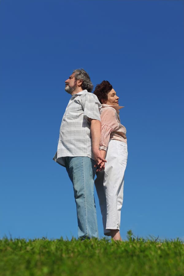 Old Woman and Man Standing Back To Back Stock Image - Image of outdoor ...