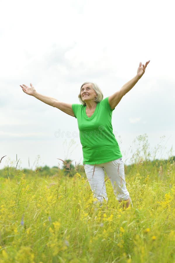 Old Woman Out for a Walk in Field Stock Photo - Image of caucasian ...