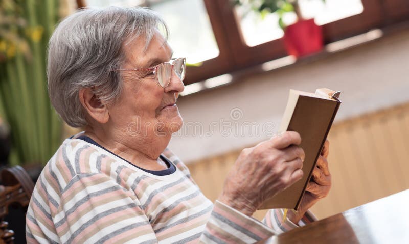 Old woman reading a book stock image. Image of woman - 165523193