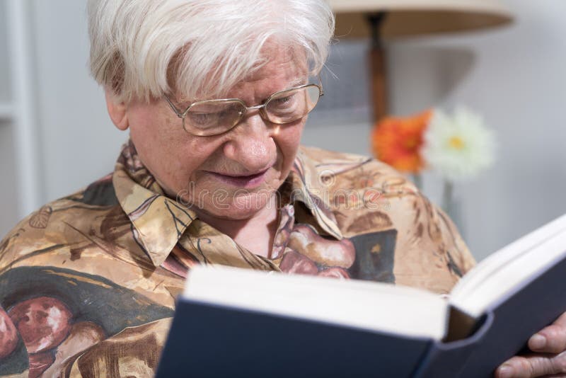 Old woman reading a book stock photo. Image of grandmother - 91442298