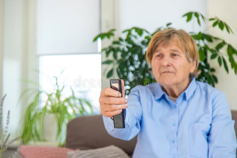 Old Woman with Remote Control in Her Hands. Selective Focus Stock Photo ...