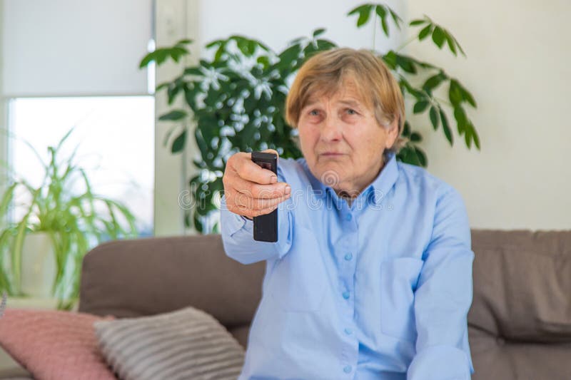 Old Woman with Remote Control in Her Hands. Selective Focus Stock Photo ...
