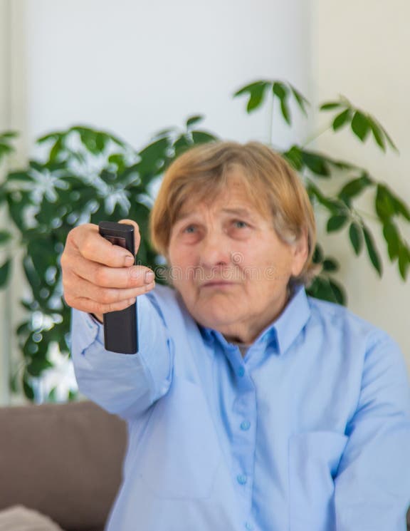 Old Woman with Remote Control in Her Hands. Selective Focus Stock Photo ...