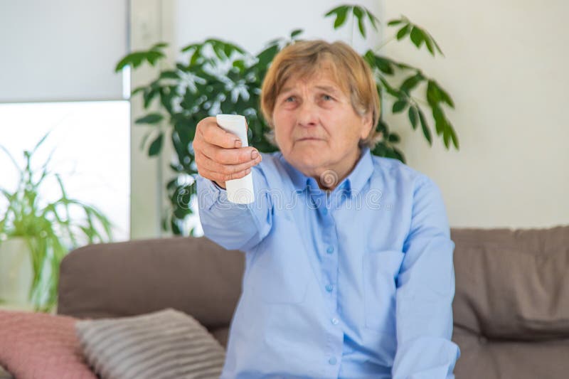 Old Woman with Remote Control in Her Hands. Selective Focus Stock Photo ...