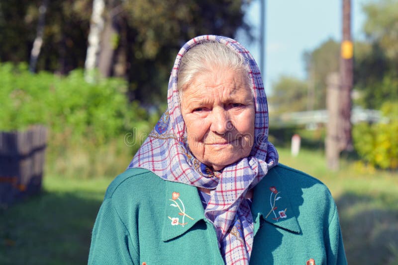 An Old Woman in a Scarf. Portrait of a Lonely Old Woman Standing in a ... An Old Woman in a Scarf. Portrait of a Lonely Old Woman Standing in a ...