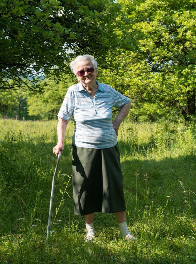 Old Woman Standing with a Cane Stock Image - Image of walking, retired ...