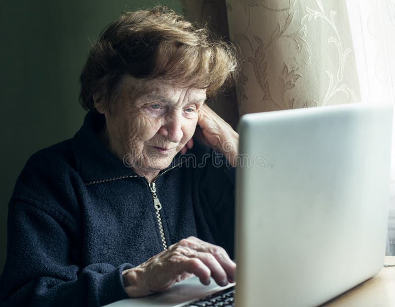 An Old Woman Studying on the Computer in Her Home. Stock Image - Image ...