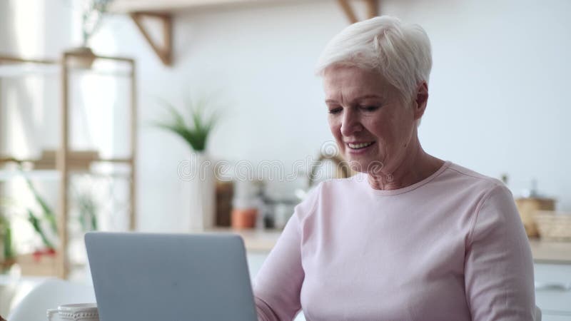 Old Woman Typing on Laptop in the Kitchen Stock Footage - Video of ...