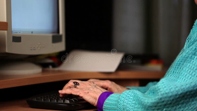Old woman using computer stock video. Video of writing - 67958757