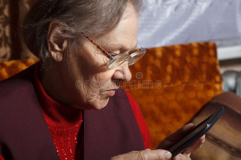 Old Woman Using Ebook Reader Stock Image - Image of person, room: 137350609