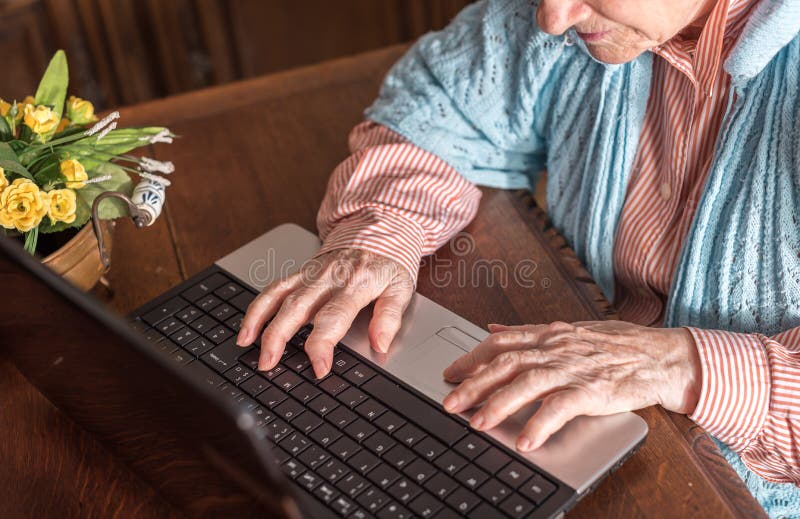 Old woman using a laptop stock photo. Image of computer - 69174586