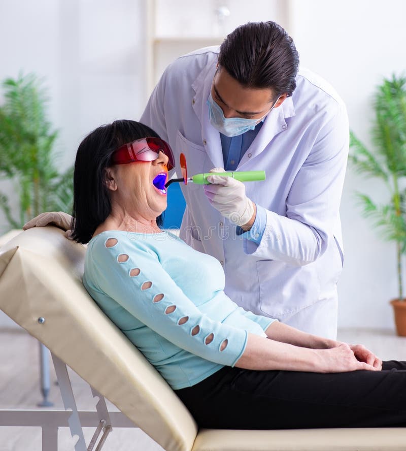 Old Woman Visiting Young Doctor Dentist Stock Image - Image of clinic ...