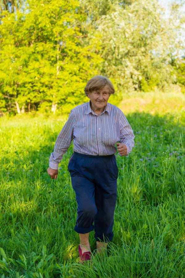 Old Woman on a Walk. Selective Focus Stock Photo - Image of outdoor ...