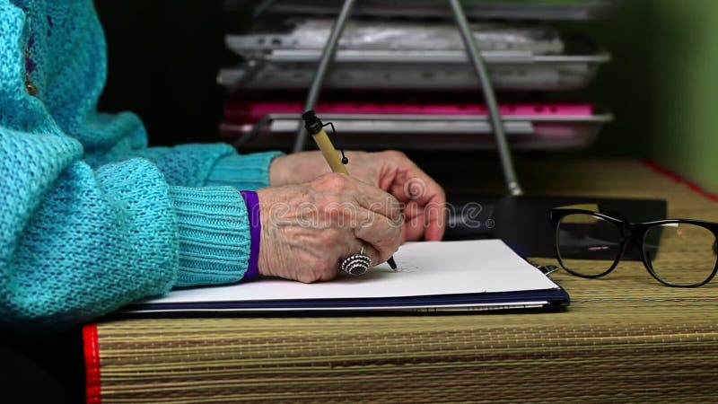 Old Woman Writing on the Paper Near Table Stock Video - Video of ...