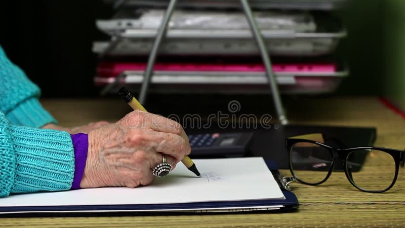 Old Woman Writing on the Paper Near Table Stock Video - Video of ...