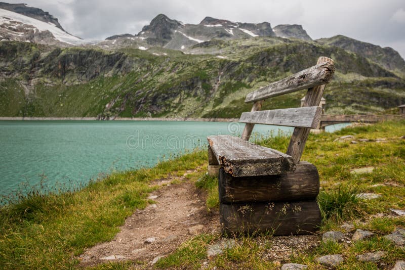 Old Wooden Bench at a Lake in Alps Stock Image - Image of grass, bench ...