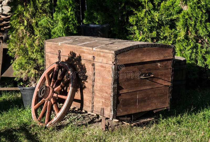 Old Wooden Chest and Wooden Cartwheel. Old Things from the Barn Stock ...