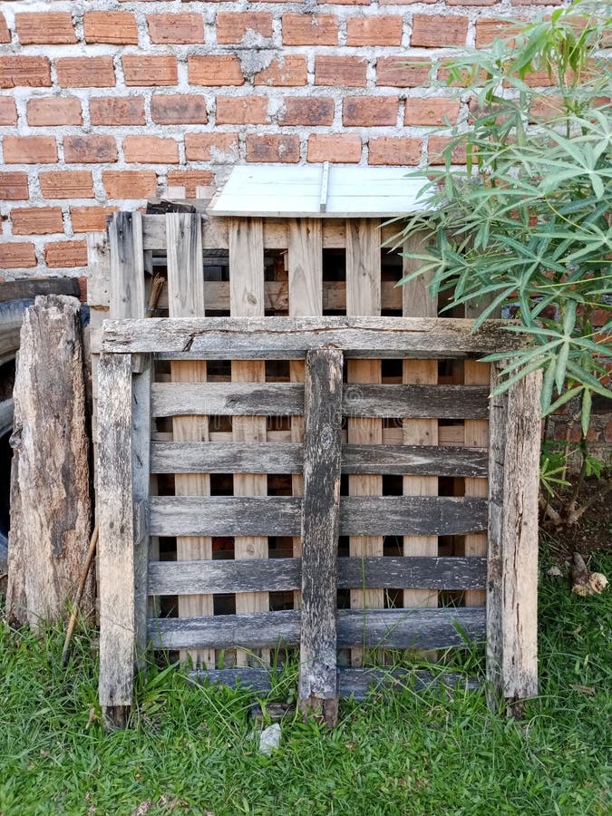 Old Wooden Pallets and Tires Stacked beside a Brick Wall Stock Photo ...