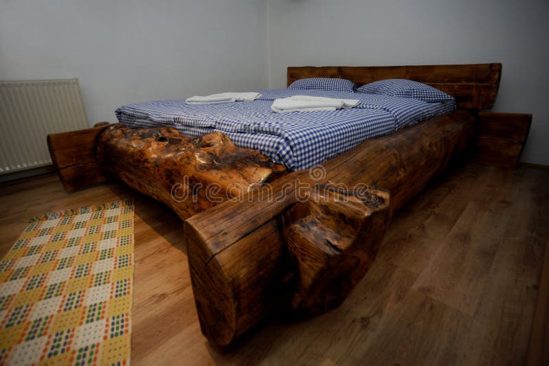 Old Wooden Rustic Bed with Blue Sheets in the Cottage Stock Photo ...
