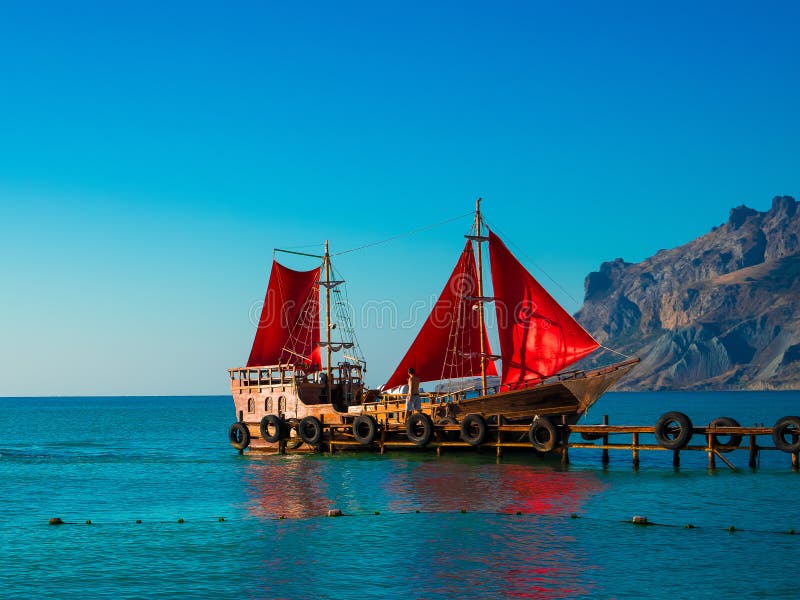 Old Wooden Ship with Red Sails on the Pier Stock Photo - Image of ...