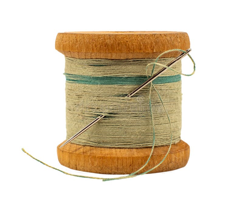 An Old Wooden Spool of Thread and a Needle on a White Background Close ...