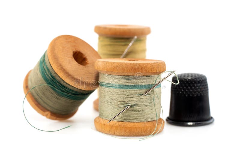 An Old Wooden Spool of Thread and a Needle on a White Background Close ...