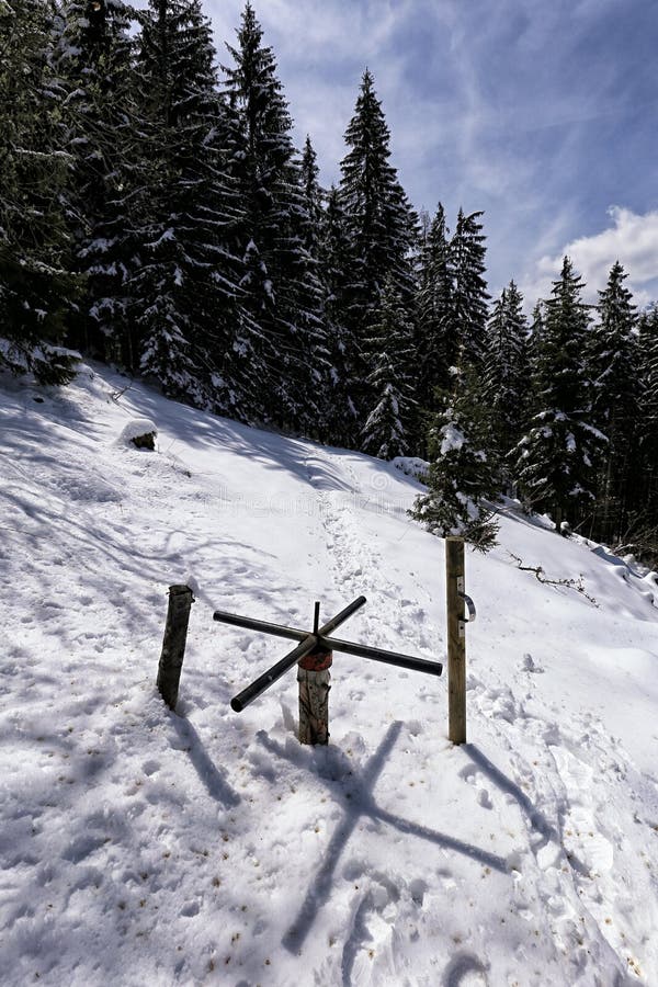 Old Wooden Turnstile in the Snowy Hillside by the Forest Stock Image ...