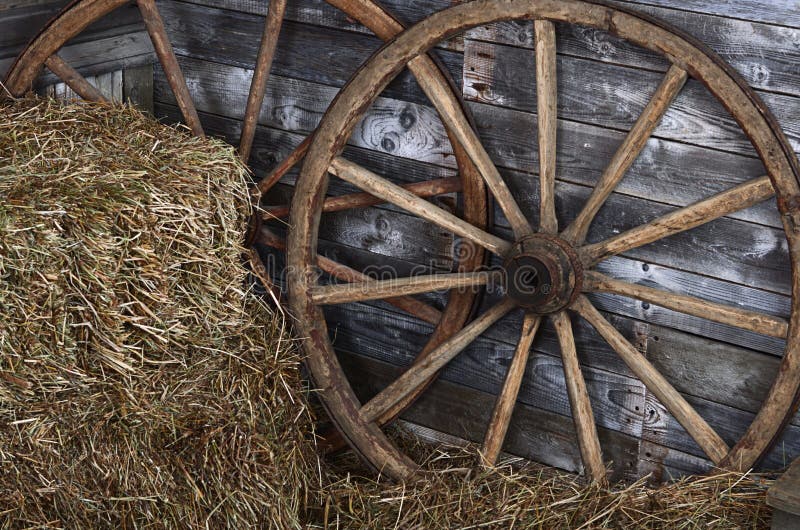 Old wooden wheel on a hay stock image. Image of cartwheel - 39119407