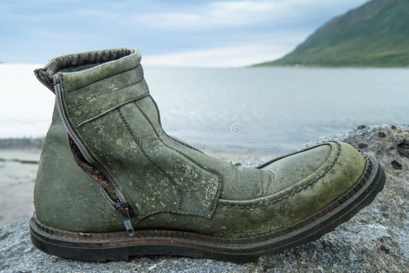 An old, worn work boot. stock photo. Image of table - 148412232