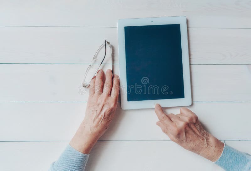 Elderly Woman Using Digital Tablet Showing Something on Display, Light ...