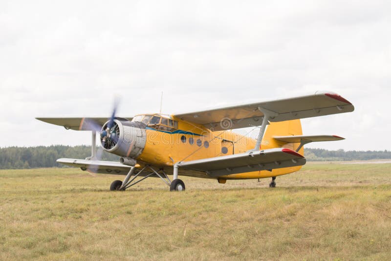 Old Yellow Biplane with Switched on Motor Stay on Grass Field Stock ...