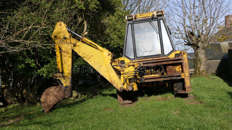 Yellow Digger Digging Foundations for an Extinction To a Bungalow with ...