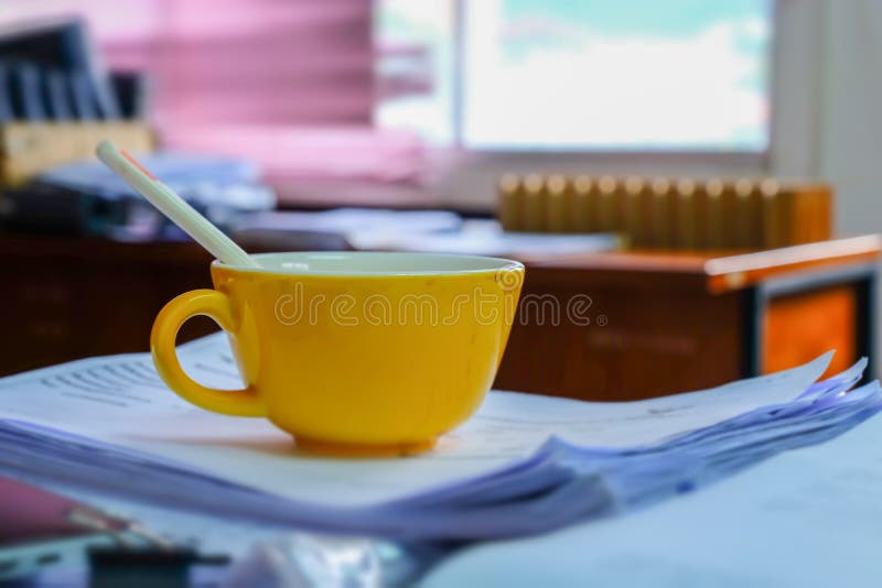 Old Yellow Glass with Coffee Stains Put on Stack Papers on the Desk ...