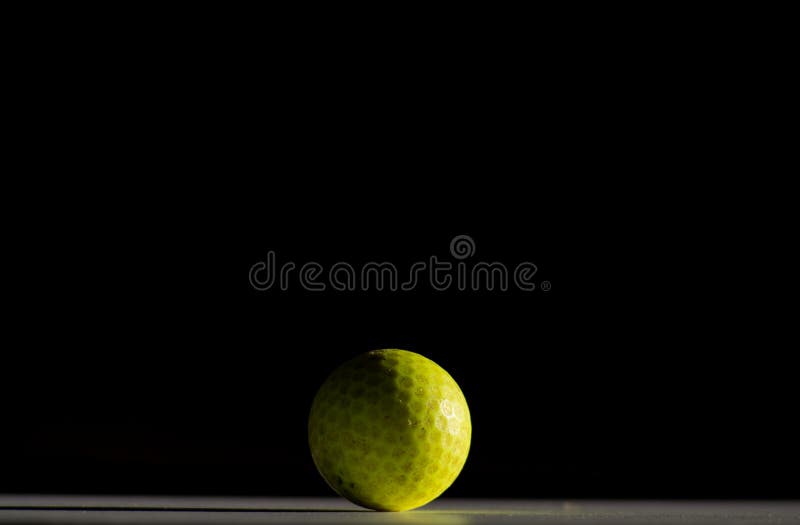 Old Yellow Golf Ball on Black Backdrop Stock Photo - Image of yellow ...