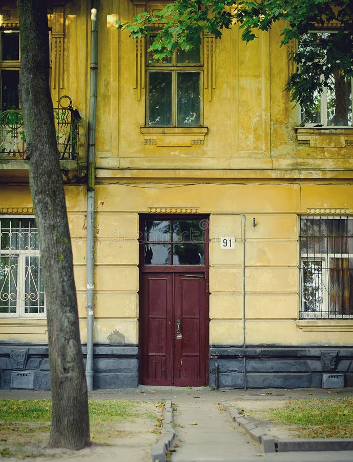 Old Yellow House Facade with Red Door Stock Image - Image of exterior ...