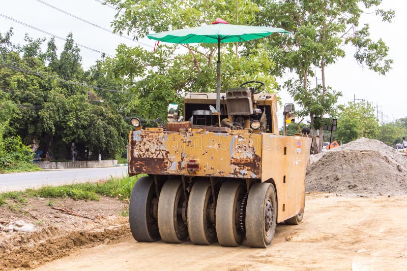 Yellow Steamroller Performing Ground Leveling Work Stock Photo - Image ...
