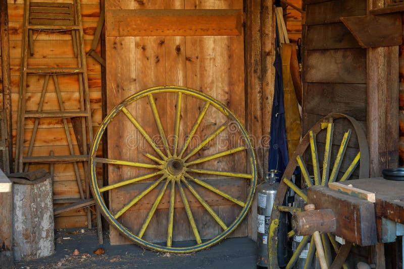 Old Yellow Wagon Wheel Waiting for Restoration in an Old Barn Stock ...