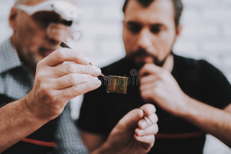 Old and Young Men Work Together in Repair Shop Stock Image - Image of ...