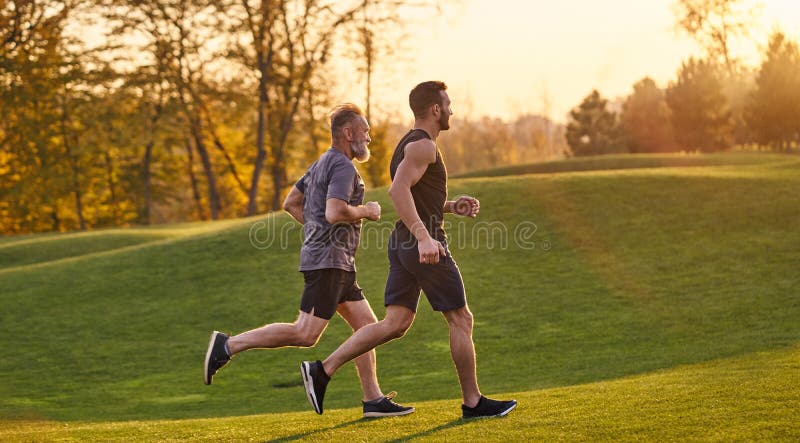 The Old and Young Sportsmen Running in the Green Park. Stock Image ...
