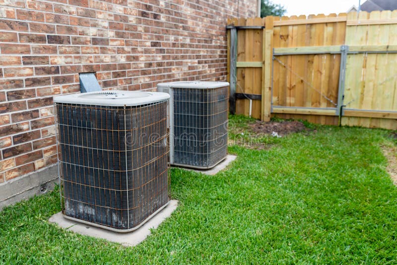 Older Air Conditioner Units Next To Brick Home with Copy Space Stock ...