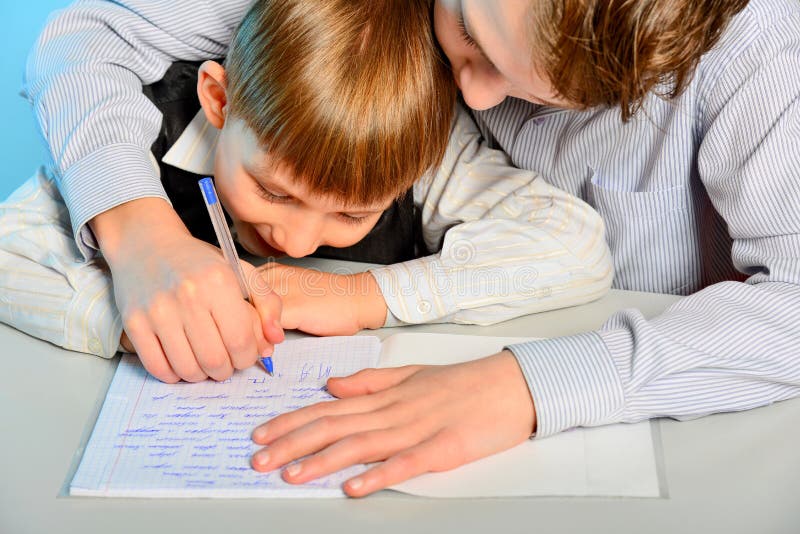 An Older Brother Helps His Younger Brother Do His Homework Stock Image ...