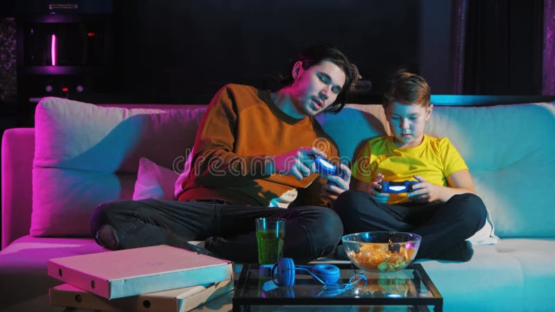 The Brother Explains To the Younger How To Play the Console Stock Video ...