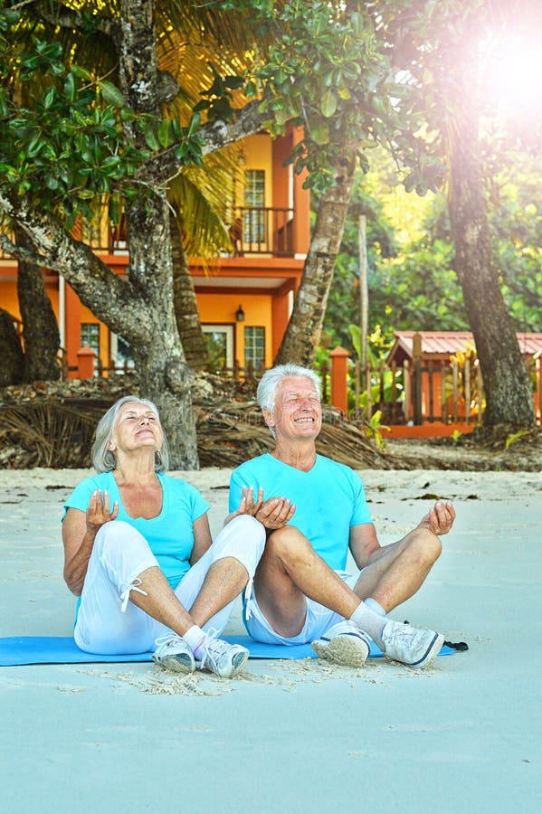 Older couple on beach stock photo. Image of people, aged - 77541564