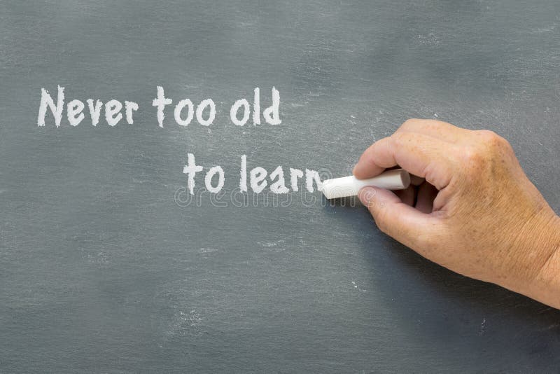 Older Hand Writes on a Chalkboard: Never Too Old To Learn Stock Image ...