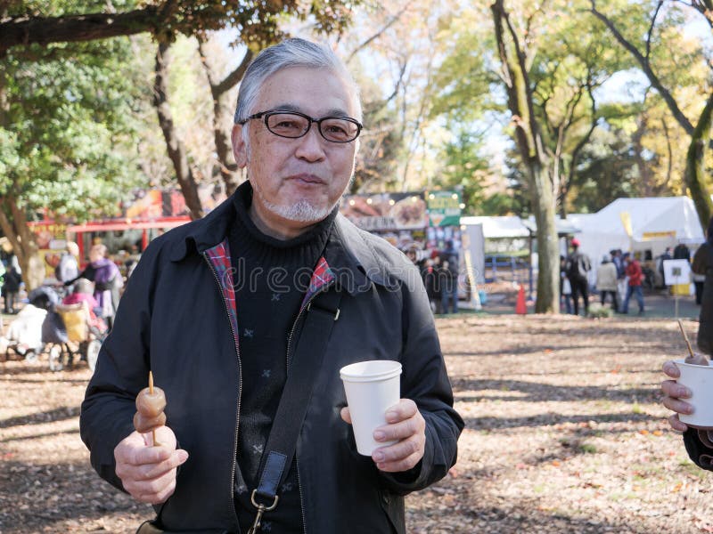 An Older Japanese Man Eating Dango and Drinking Coffee Stock Image ...
