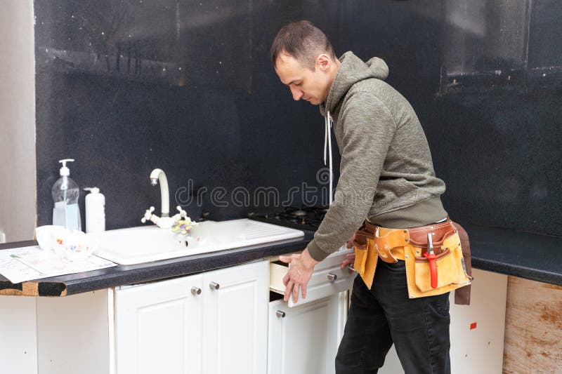 Older Man Disassembling Apartment Kitchen Out of Service Stock Photo ...