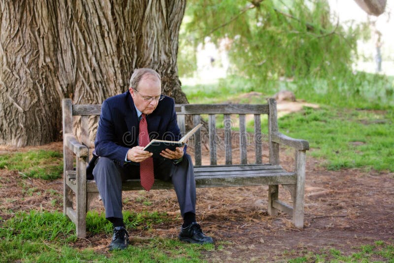 Older Man Enjoys Book stock photo. Image of business, worker - 9911346