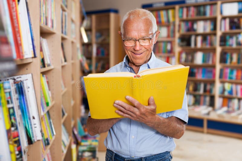 Older Man Reader Browsing Inside of Books in Bookshop Stock Photo ...